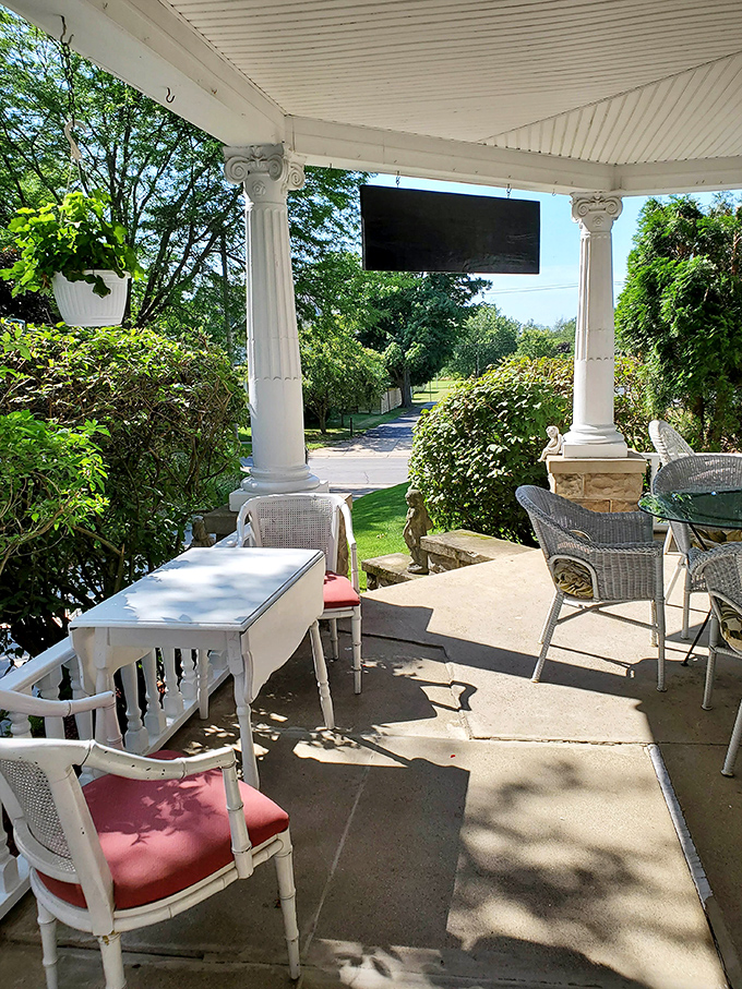 Another view of the inviting porch, where white wicker furniture practically whispers "Sit a spell" to everyone who passes by.