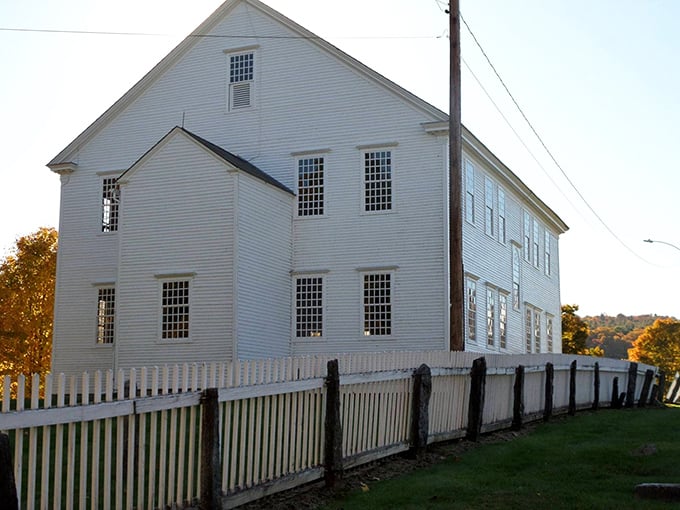 The Rockingham Meeting House stands pristine and white against Vermont's rolling hills, its simple Puritan design unchanged since the late 18th century.