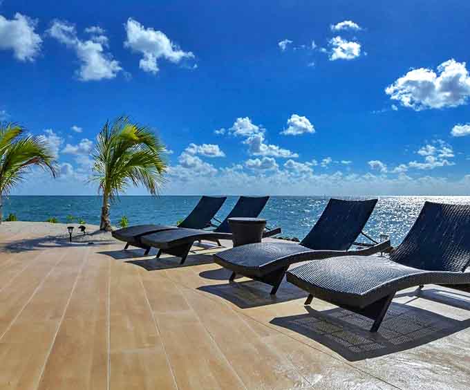Loungers positioned at the ocean's edge offer the perfect vantage point for contemplating life's big questions or simply your next cocktail.