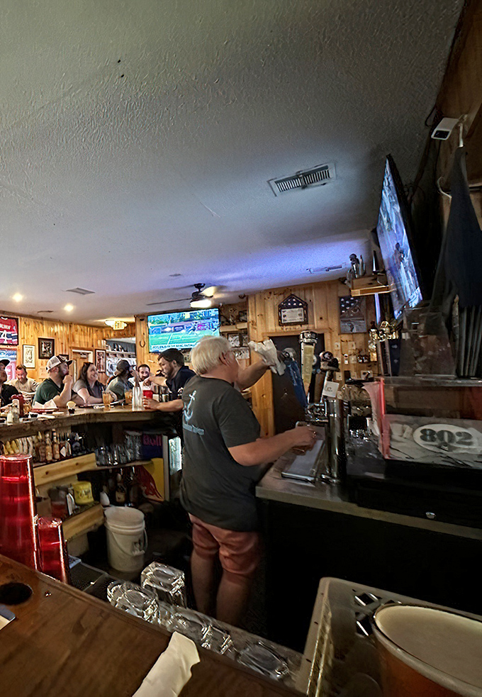 The wizard behind the bar crafts perfect pours while patrons eagerly await their orders &ndash; decades of tavern expertise in every movement.