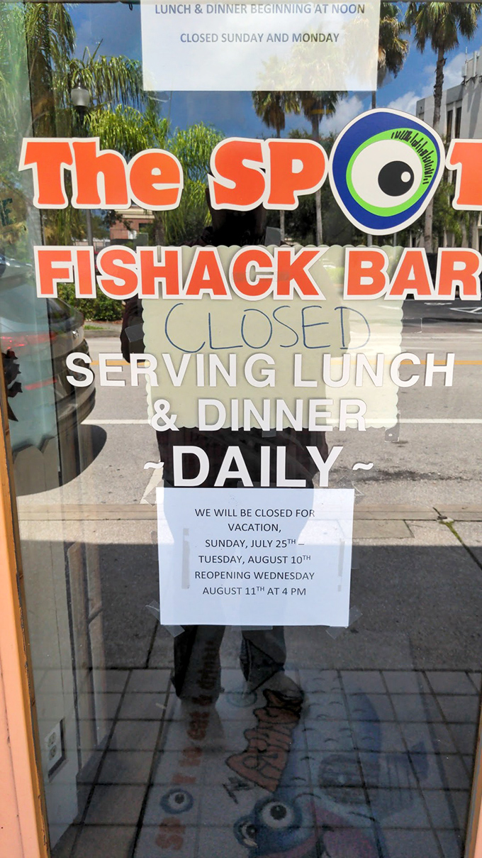 The door sign that breaks hearts when it announces vacation closures &ndash; proof that even seafood superheroes need occasional rest.