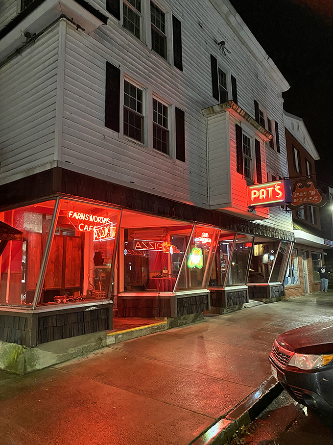 Night falls but Pat's Pizza shines on – the red glow of the windows promising warmth and satisfaction inside.