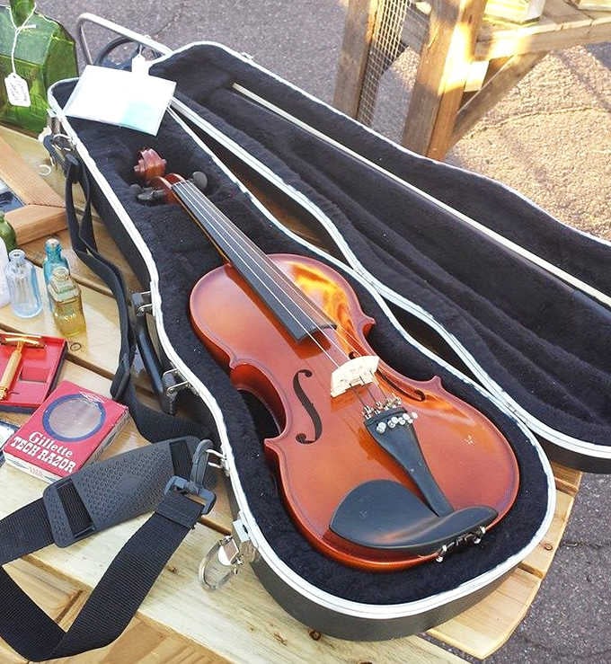 A violin resting in its case, waiting for someone to wake up its voice and make beautiful music again.