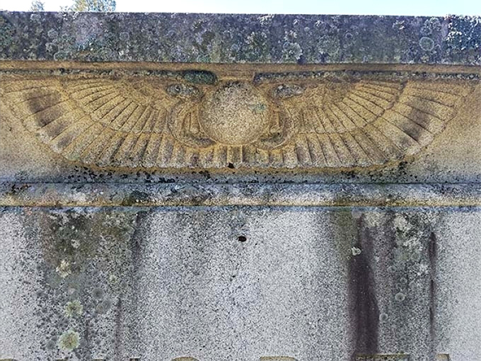 Ancient Egyptian symbolism meets Vermont granite in this weathered carving—immortality expressed through enduring stone.