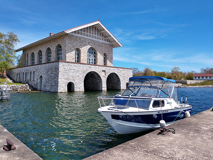 Modern meets historic as a pleasure craft docks at the century-old boathouse, creating a perfect juxtaposition of different eras of island life.