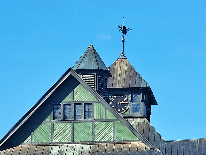The clock tower keeps farm time, its weathervane spinning stories of Vermont winds to those who pause to look up.