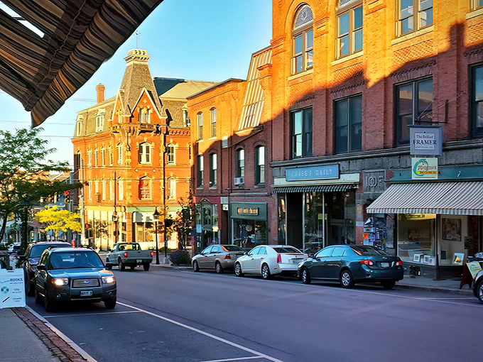 Golden hour transforms Belfast's Main Street into a warm, inviting corridor of brick and history bathed in sunset glow.