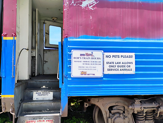 The entrance invites adventurous eaters to step aboard for a unique dining experience, complete with posted hours for planning your culinary journey.