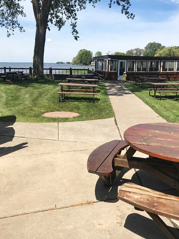 Outdoor seating with Lake St. Clair views, where picnic tables become front-row seats to nature's show, with burgers as the perfect companion.