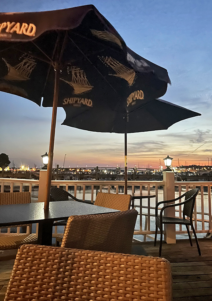 Shipyard umbrellas frame the perfect evening tableau. That empty chair isn't lonely &ndash; it's waiting for you to claim the best seat in South Portland.
