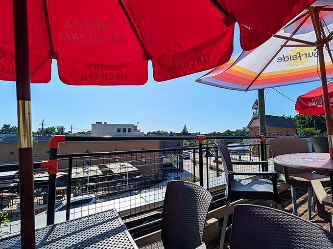 Red umbrellas dot the rooftop deck like cherries on a sundae, offering shade and style for those dining with a view.