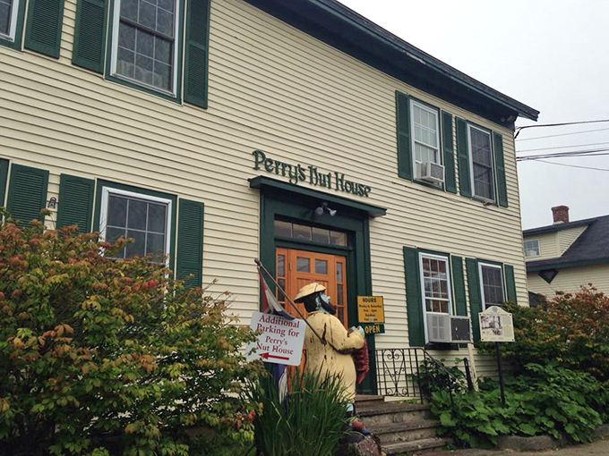 The exterior view shows Perry's welcoming entrance, where a statue stands guard, inviting travelers to step into a world of sweet surprises.