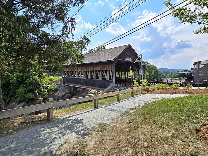 A charming covered bridge and peaceful riverside path invite a leisurely stroll and quiet reflection.