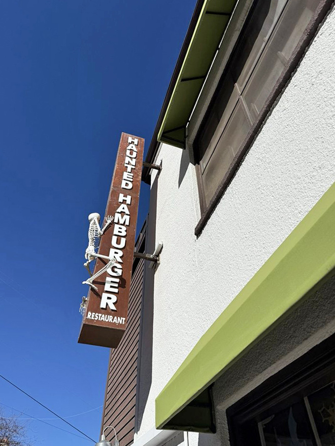 The vertical "Haunted Hamburger" sign with its skeletal mascot serves as Jerome's most deliciously macabre landmark against the Arizona sky.