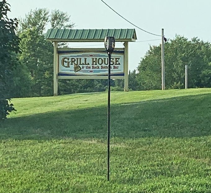 The Grill House sign stands proudly along the roadside &ndash; a beacon for hungry travelers seeking something beyond the ordinary.