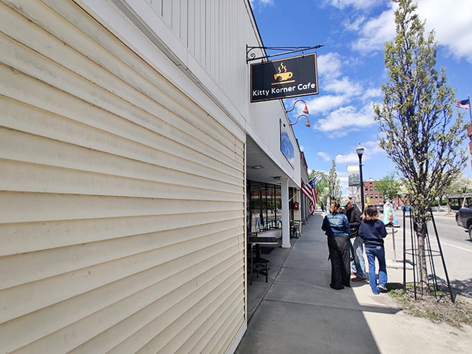 The caf&eacute;'s charming exterior sign beckons cat lovers and coffee enthusiasts alike to this Main Street treasure.