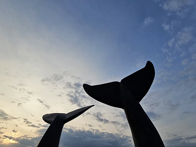 Twilight silhouettes the massive sculptures against the fading light, their distinctive shapes recognizable from any angle.