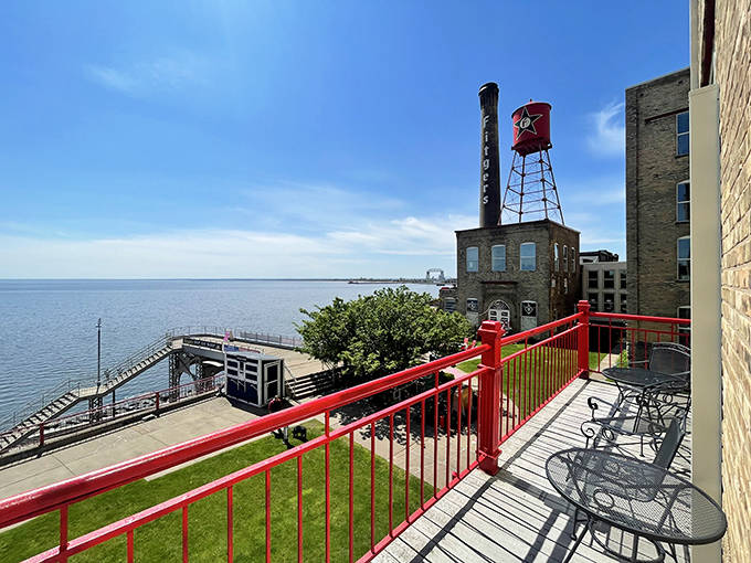 That iconic red water tower stands sentinel over Lake Superior's vastness – a view that turns every meal into a postcard moment.