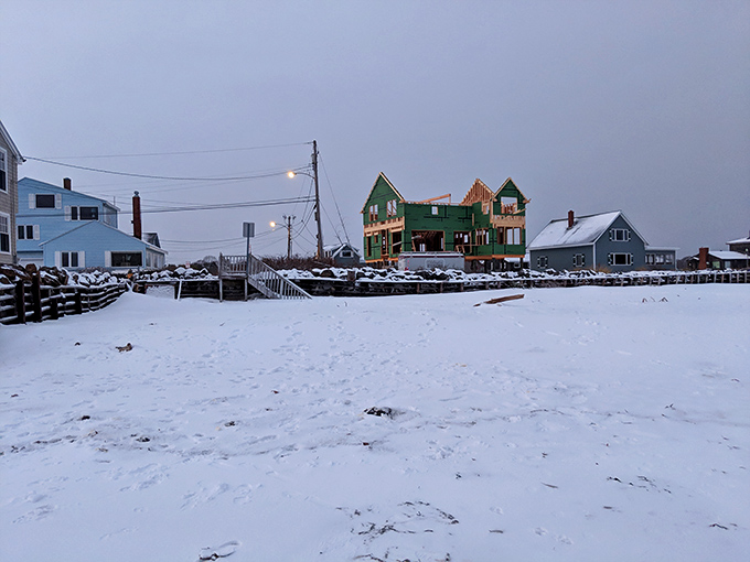 Dramatic storm clouds gather over peaceful waters, creating that quintessential Maine coastal mood that artists have tried to capture for centuries.