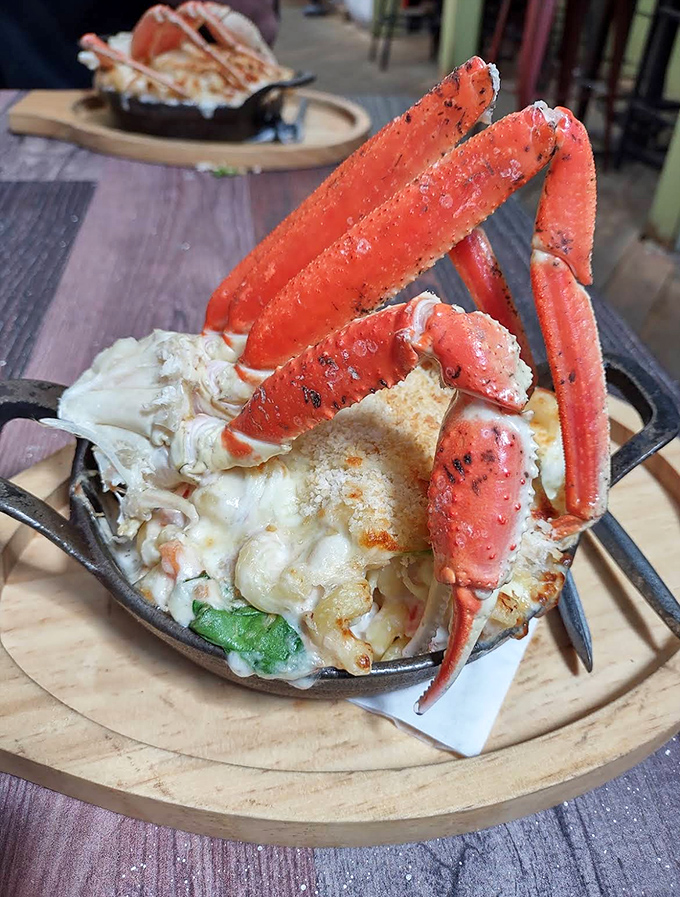 Snow crab legs reach dramatically skyward from this mac and cheese &ndash; seafood luxury meets comfort food in a cast-iron masterpiece.