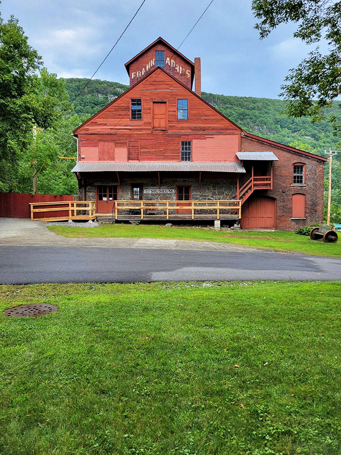 The Adams Grist Mill's rustic red exterior houses fascinating industrial history, where water power once transformed grain into the staff of life.
