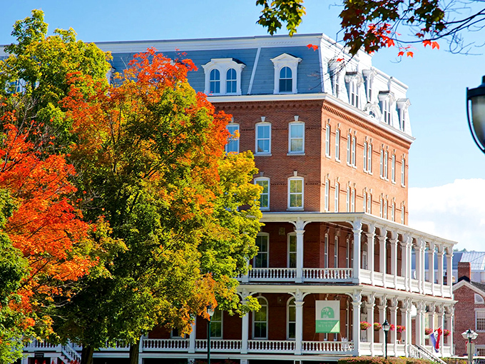 The Pavilion's historic brick fa&ccedil;ade glows warmly against autumn foliage, a perfect example of how Montpelier's architecture harmonizes with its natural setting.