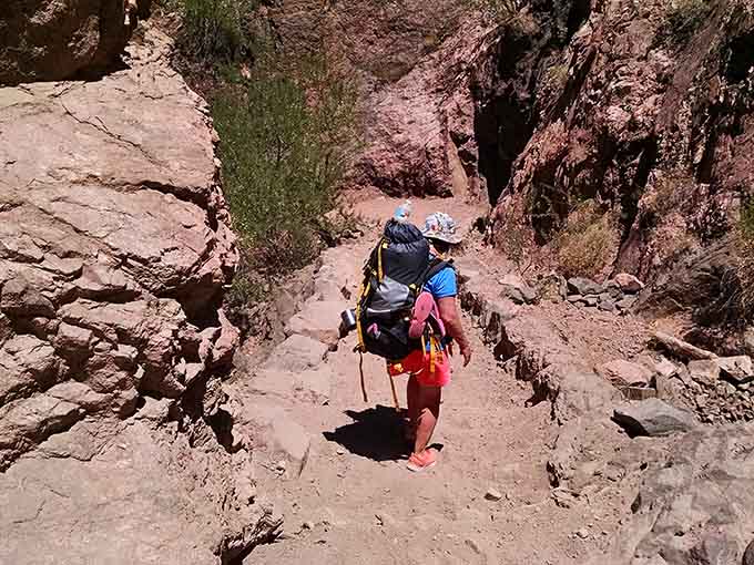 The Colorado River flows relentlessly below, the same force that carved this entire canyon one grain of sand at a time.