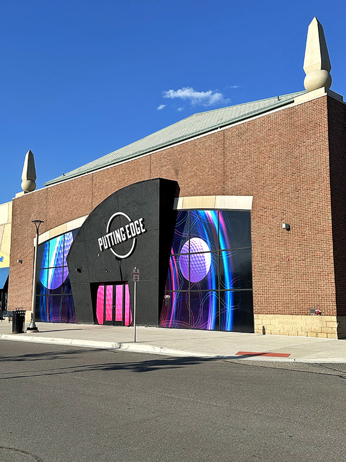 "Putting Edge" brings glow-in-the-dark mini-golf thrills to life behind these vibrant, neon-splashed doors—pure family fun awaits inside!