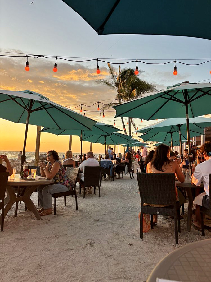 Diners: Sunset transforms ordinary moments into magic as patrons dine with their toes in the sand and eyes on the horizon.