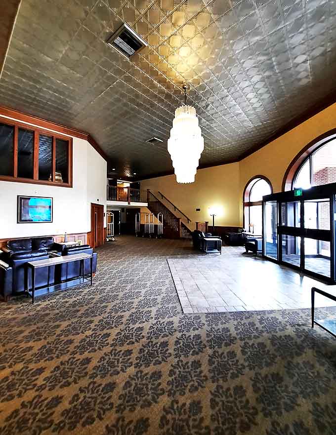 The spacious lobby with its second-floor balcony welcomes guests with comfortable seating areas perfect for planning adventures or simply watching the world go by.