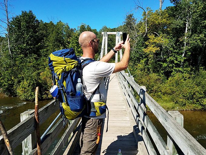 Equipped for exploration, this modern adventurer captures memories of the bridge, preserving moments that words alone could never fully describe.