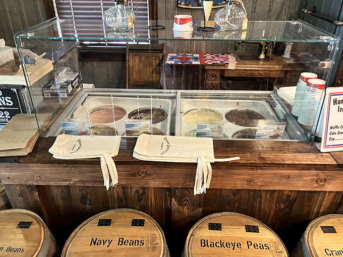 Ice cream flavors await beneath glass, promising the kind of simple pleasure that hasn't changed much since your grandparents' first date.