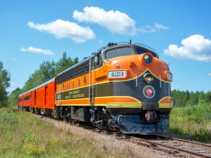 The full train in motion, a colorful serpent winding through Wisconsin's countryside, connecting passengers to simpler times.