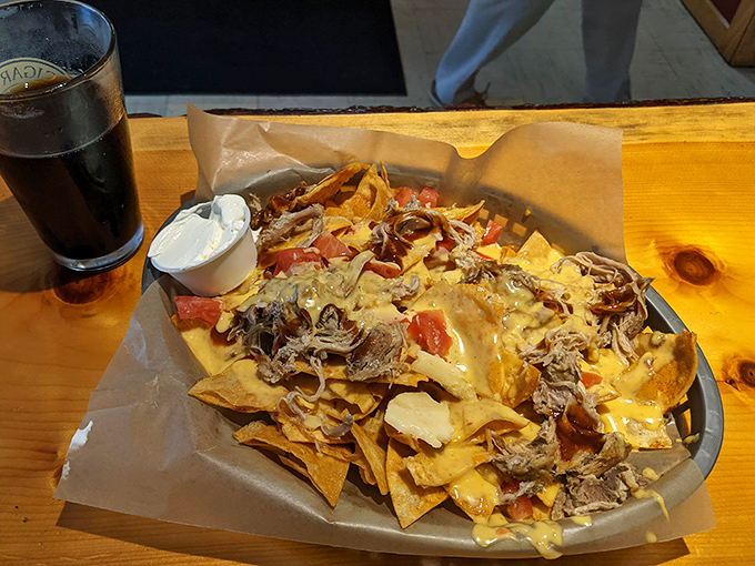 BBQ nachos that defy gravity and good sense - a mountain of chips, cheese, and pulled pork that's worth every messy bite.