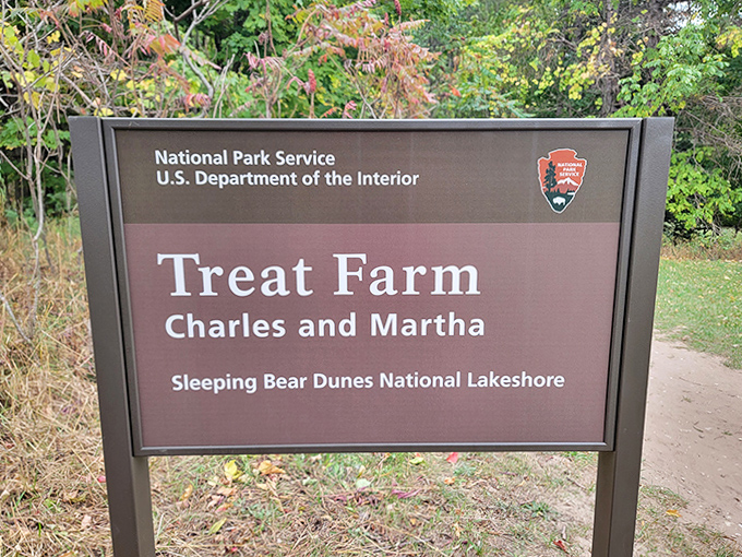 The Treat Farm sign marks your entry to adventure, where history and natural beauty converge in perfect Michigan harmony.