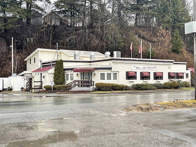 The exterior view shows off those burgundy awnings and classic diner lines that make this place instantly recognizable as a temple of comfort food and community.