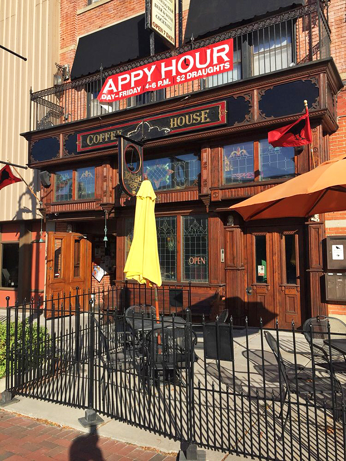 Outdoor seating protected by wrought iron fencing offers the perfect vantage point for people-watching while sipping your favorite brew.