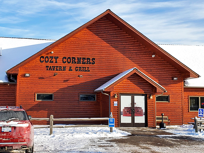 Even in winter, that distinctive red cabin stands out against the snow – promising warmth, comfort, and food that sticks to your ribs when you need it most.