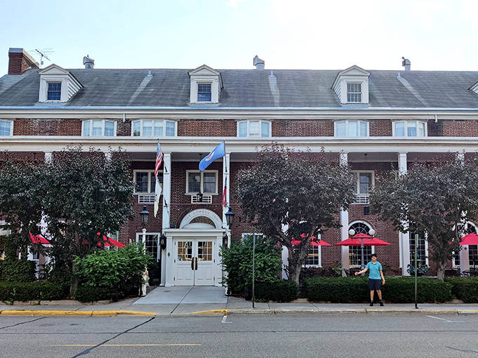 The Lowell Inn's fa&ccedil;ade captures Minnesota's architectural heritage &ndash; its brick exterior, symmetrical windows, and American flag creating a postcard-perfect scene in downtown Stillwater.