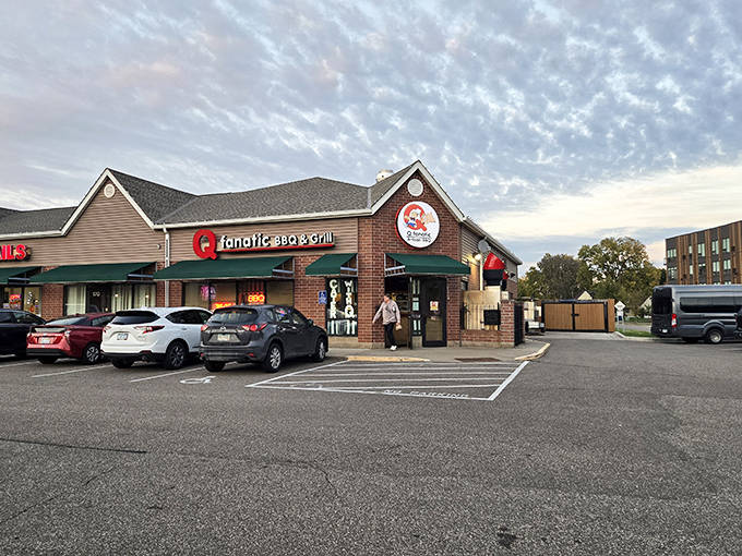 Outside: As dusk falls, the glowing windows of Q Fanatic beckon hungry travelers like a barbecue lighthouse in a sea of chain restaurants.