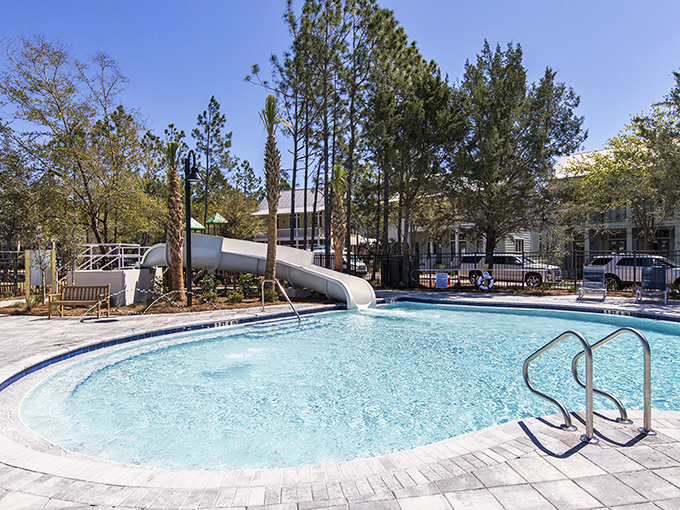 A pool with a slide because adults deserve permission to play too &ndash; childhood joy with better swimwear and no parental supervision.
