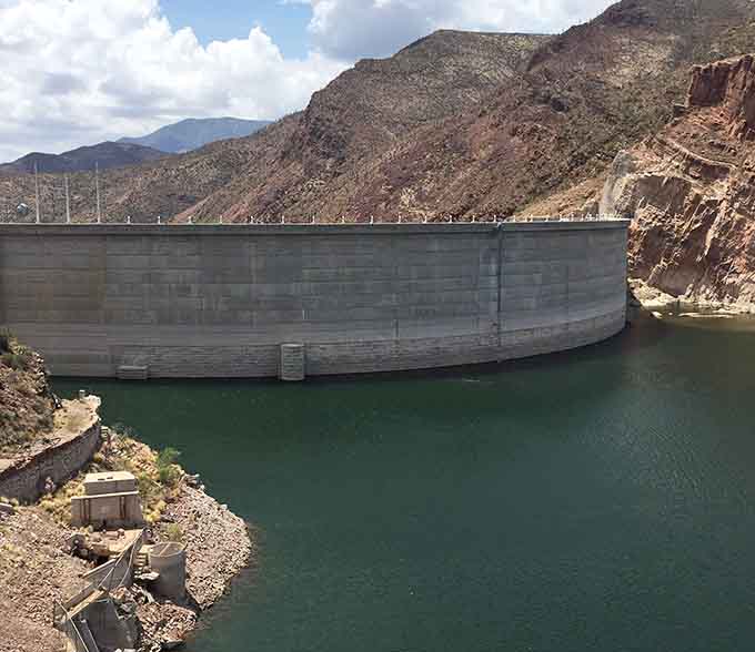 Roosevelt Dam's massive concrete face holds back millions of gallons, a engineering marvel that still impresses over a century later.