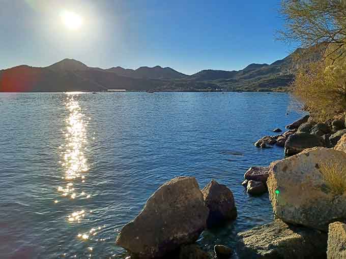Calm water reflects the sky like a mirror, creating that peaceful atmosphere that makes you understand why people have been drawn to lakes since forever.