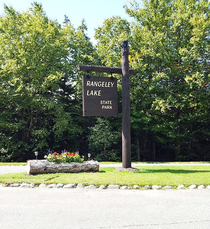 The welcoming gateway to natural splendor &ndash; Rangeley Lake State Park's sign promises adventures that no digital experience could ever hope to match.