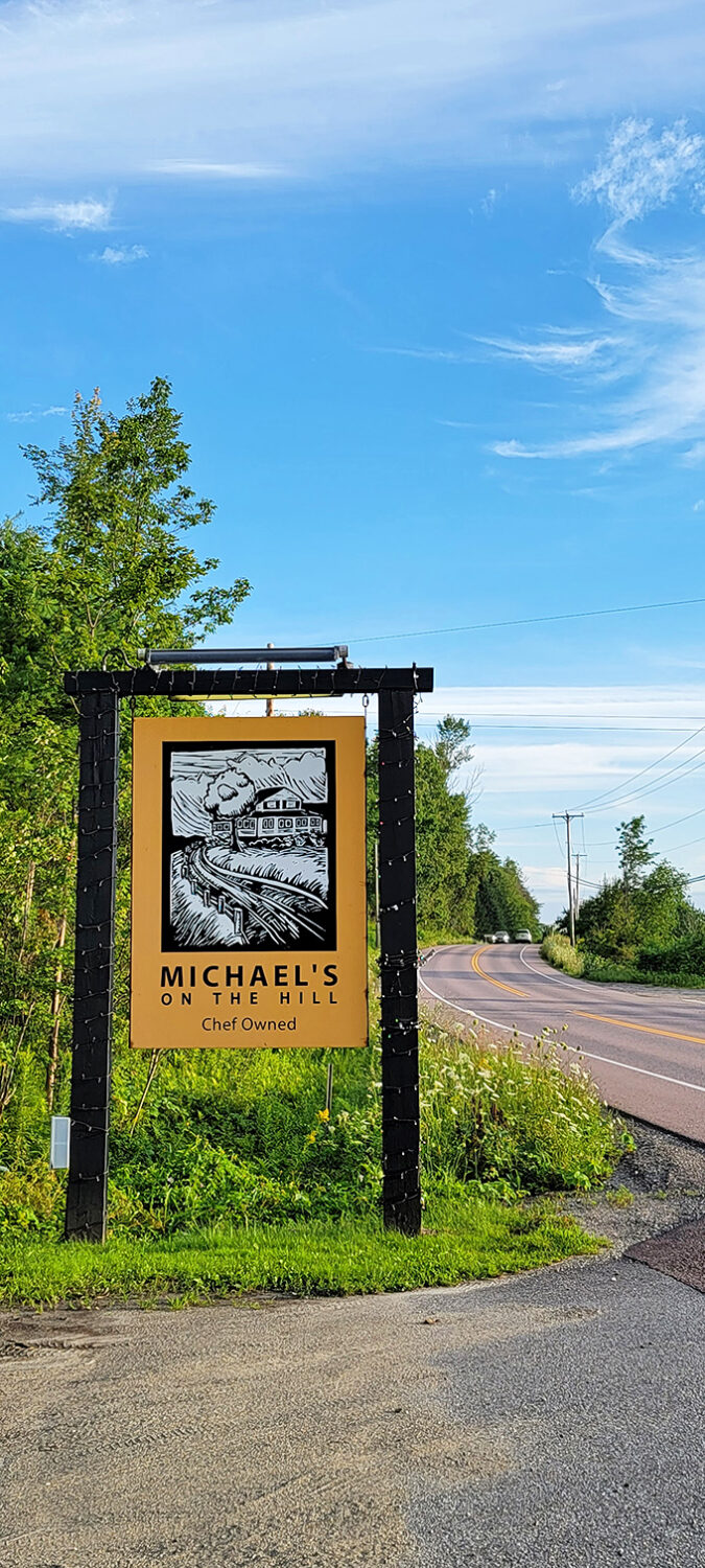 The roadside sign stands as a humble ambassador for the culinary excellence that awaits &ndash; a beacon for food lovers in-the-know.