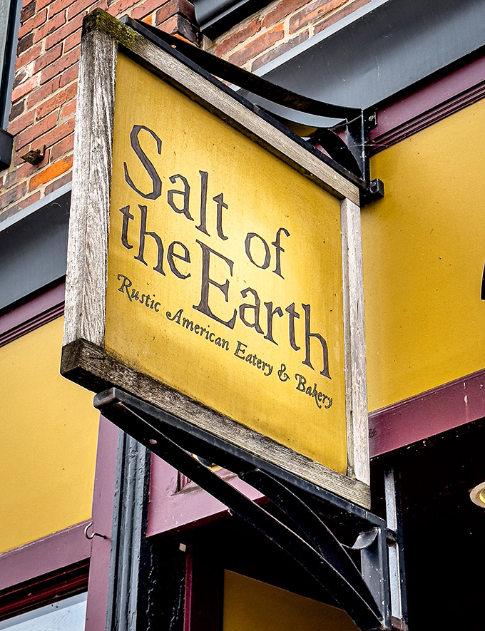 The weathered wooden sign announces not just a restaurant but a philosophy: rustic American food prepared with care and integrity.
