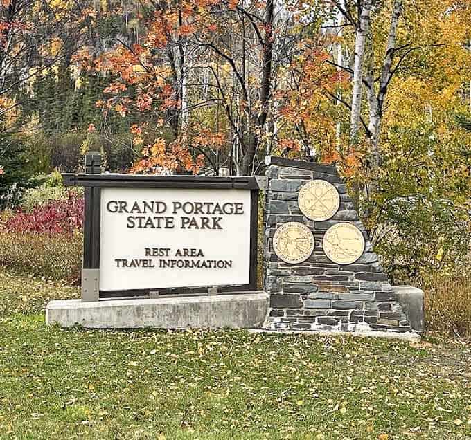 The park's entrance sign stands as a humble introduction to the natural wonders beyond, like a modest doorway leading to an unexpected palace.