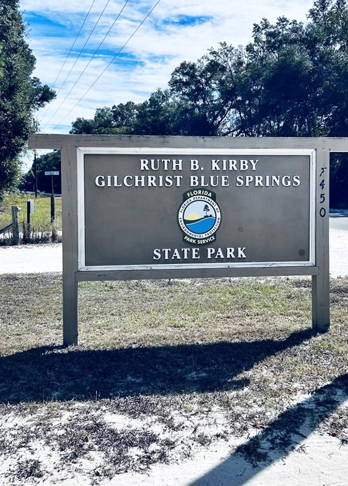 The welcoming gateway to paradise &ndash; Gilchrist Blue Springs State Park sign standing proudly under Florida's impossibly blue skies.