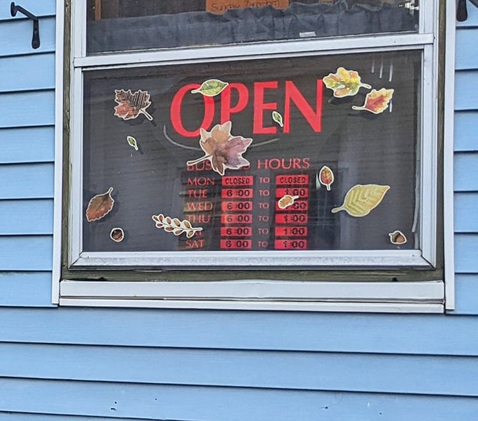 Seasonal hours posted with fall decorations, a reminder that Deb's operates on Maine time, not big-city schedules.