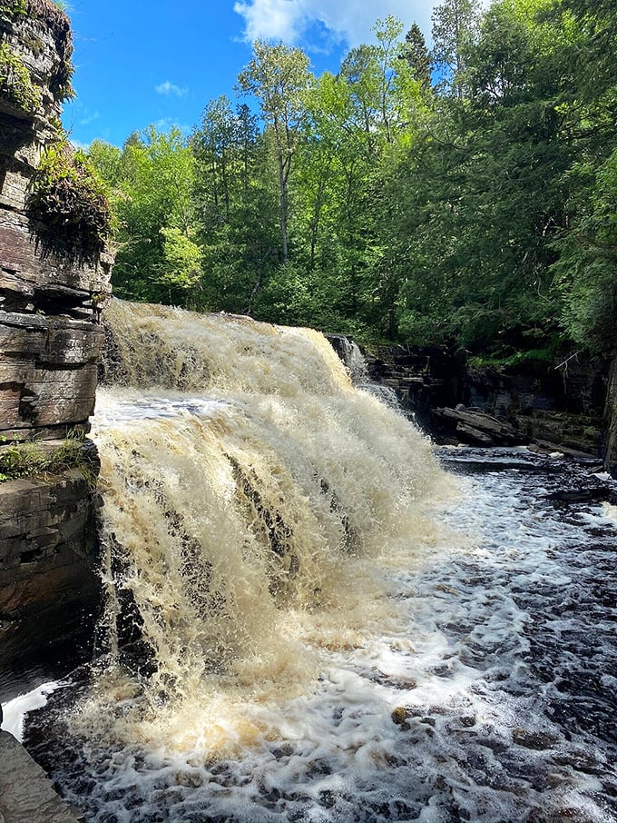 Water and gravity collaborate on a masterpiece, as sunlight catches the spray to create ephemeral rainbows in the mist.